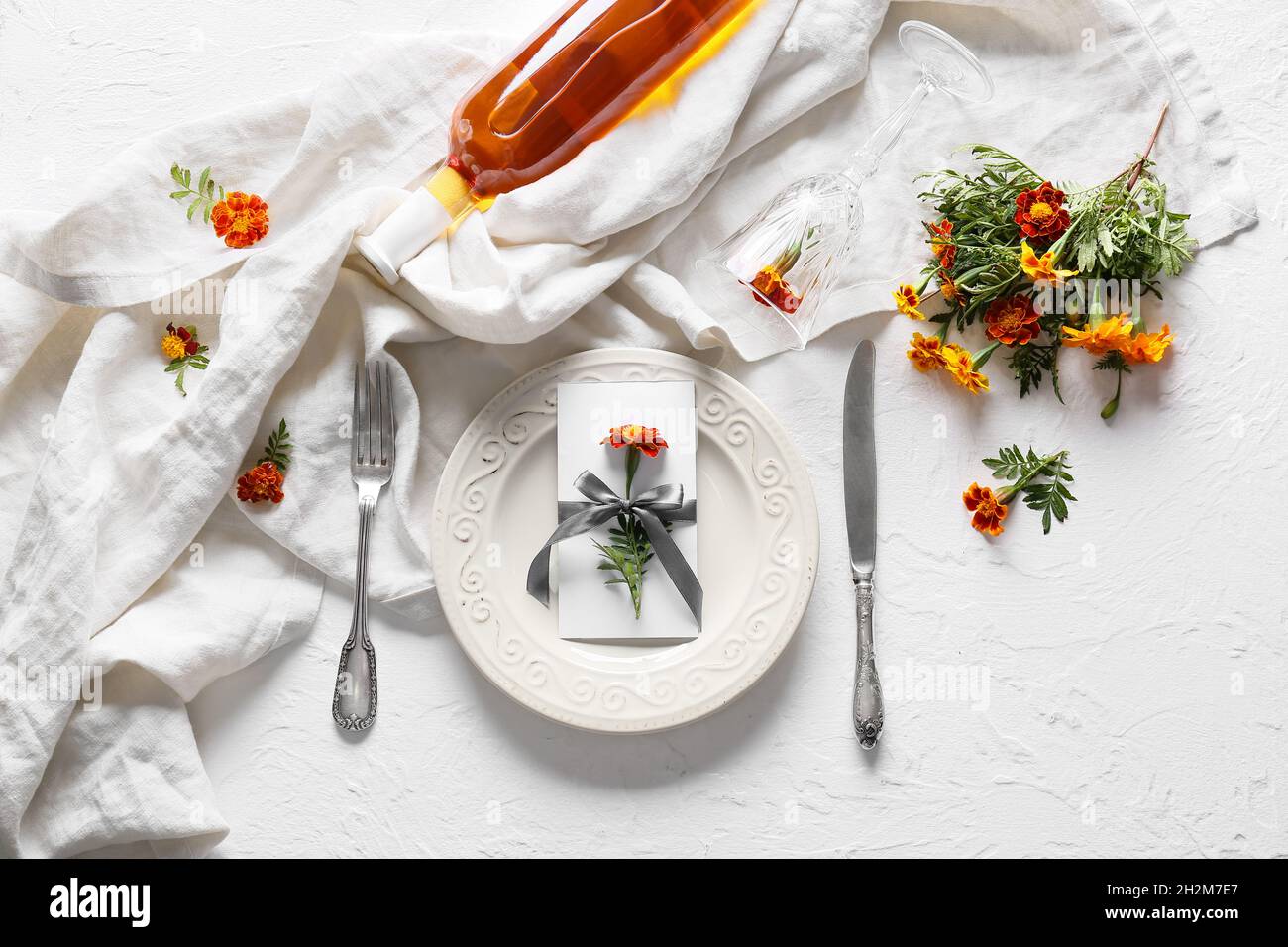 Beautiful table setting with marigold flowers on light background Stock ...