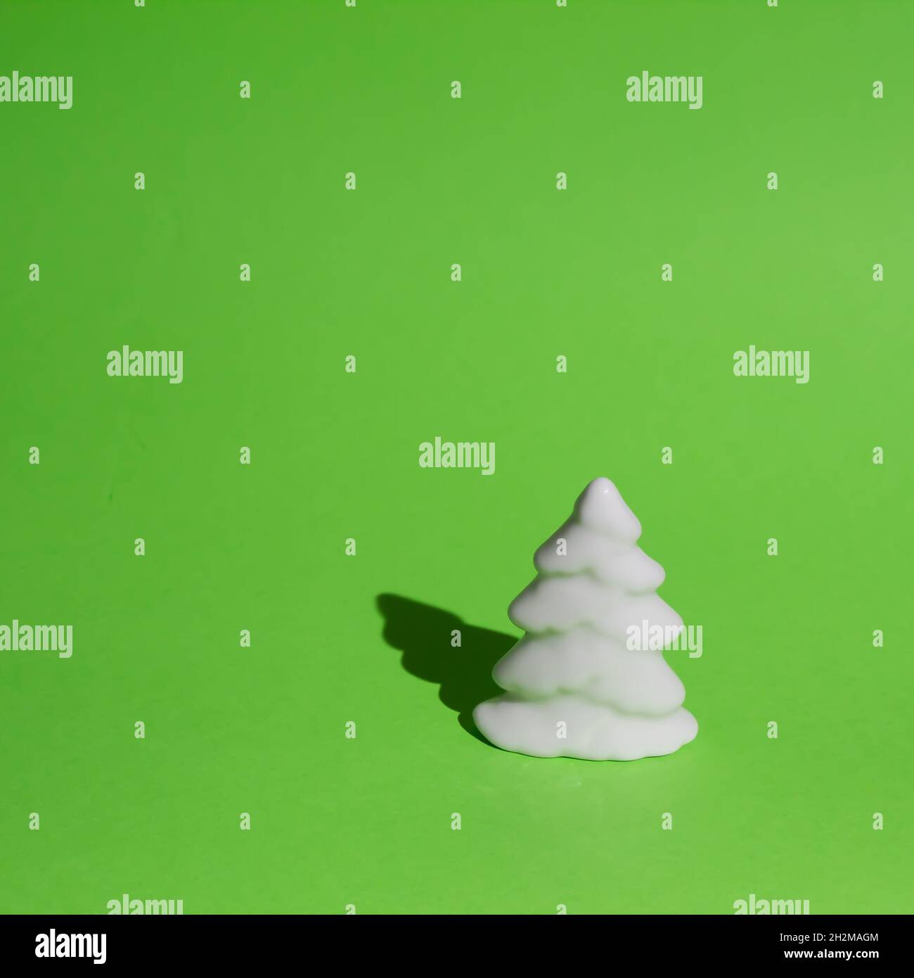 Christmas tree on a pastel green background Stock Photo - Alamy