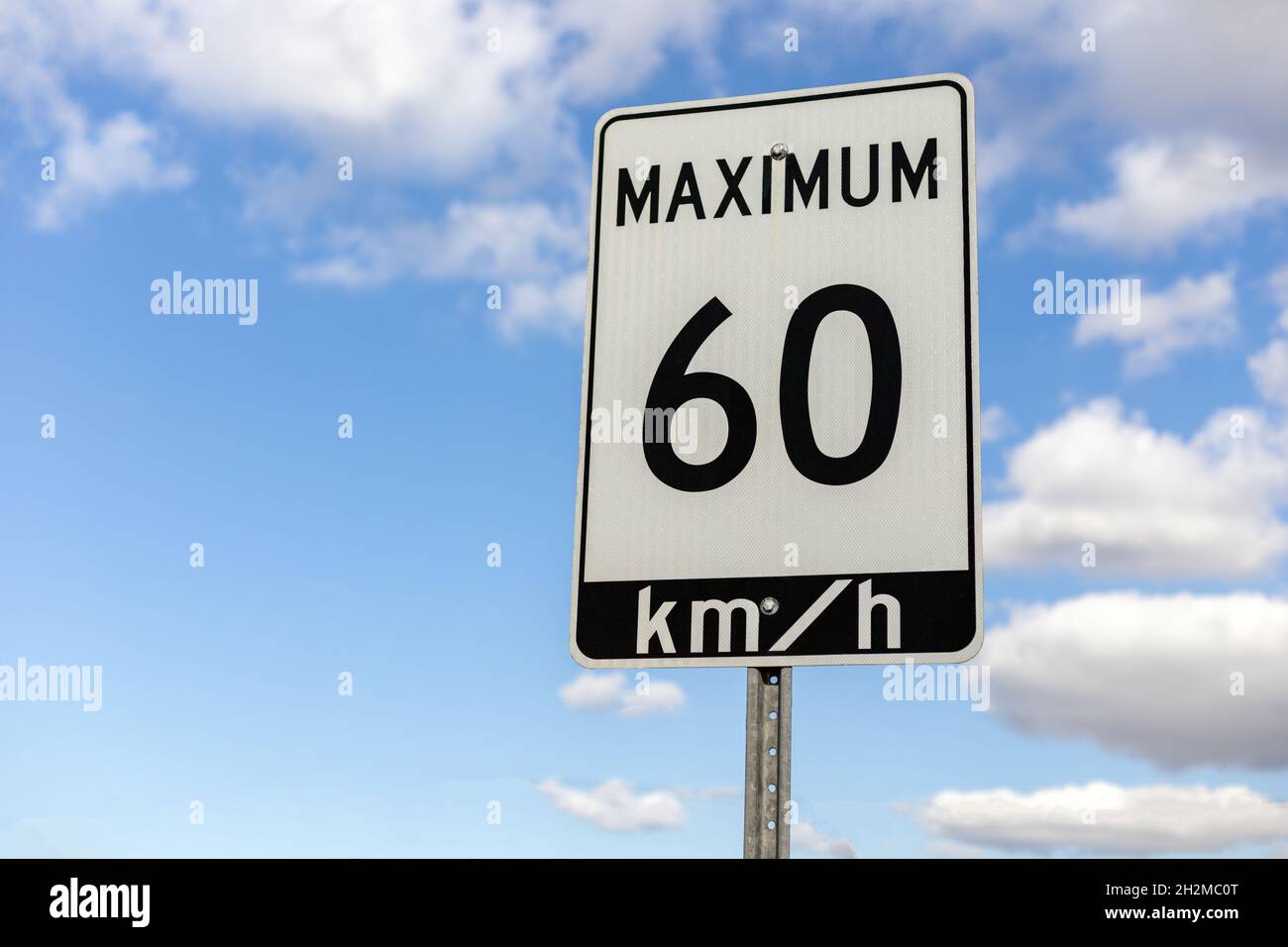 Speed limit road sign against blue sky with clouds, 60 km maximum ...