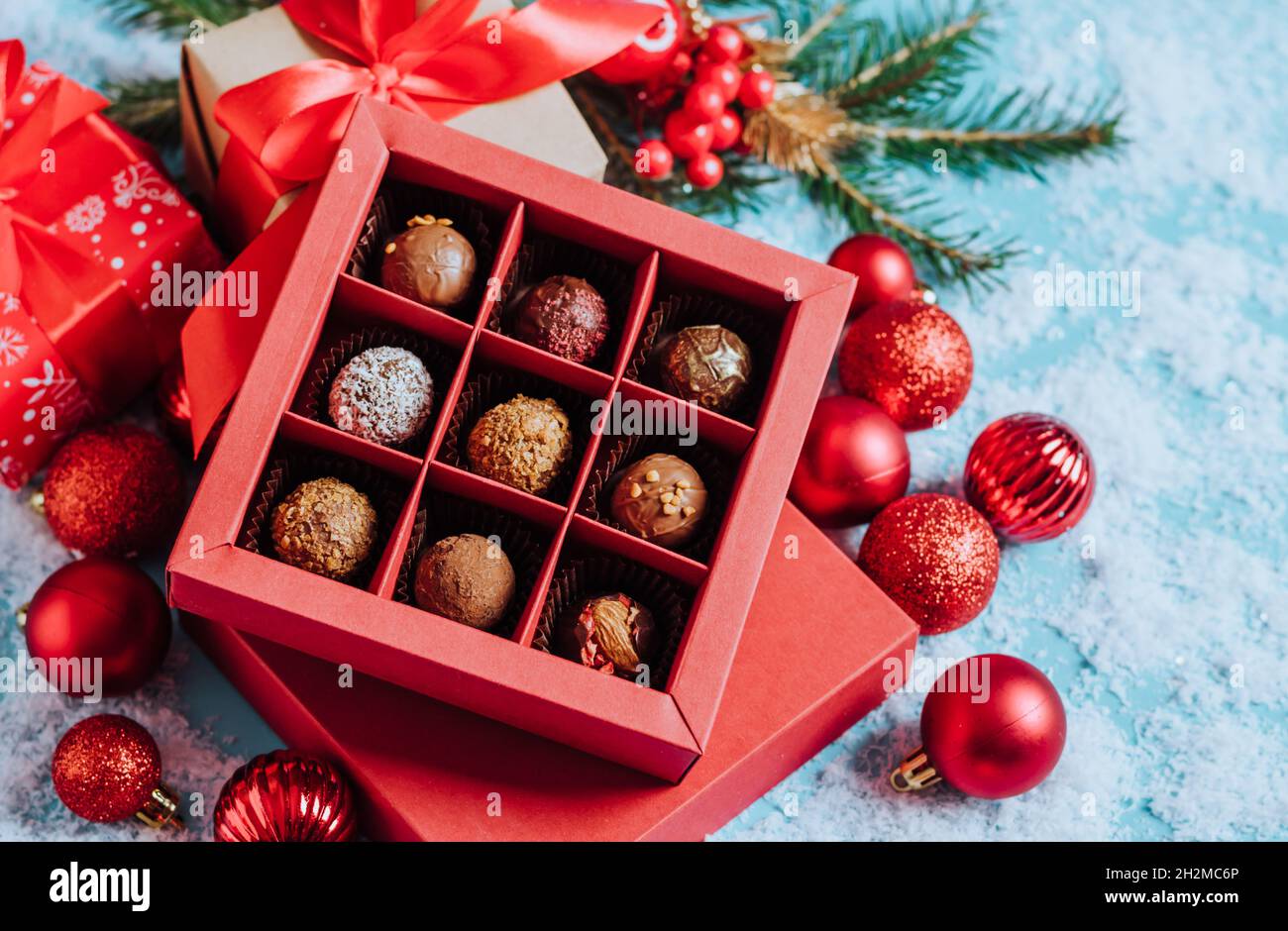 Chocolates in a red festive box dark chocolate truffle on a Christmas ...