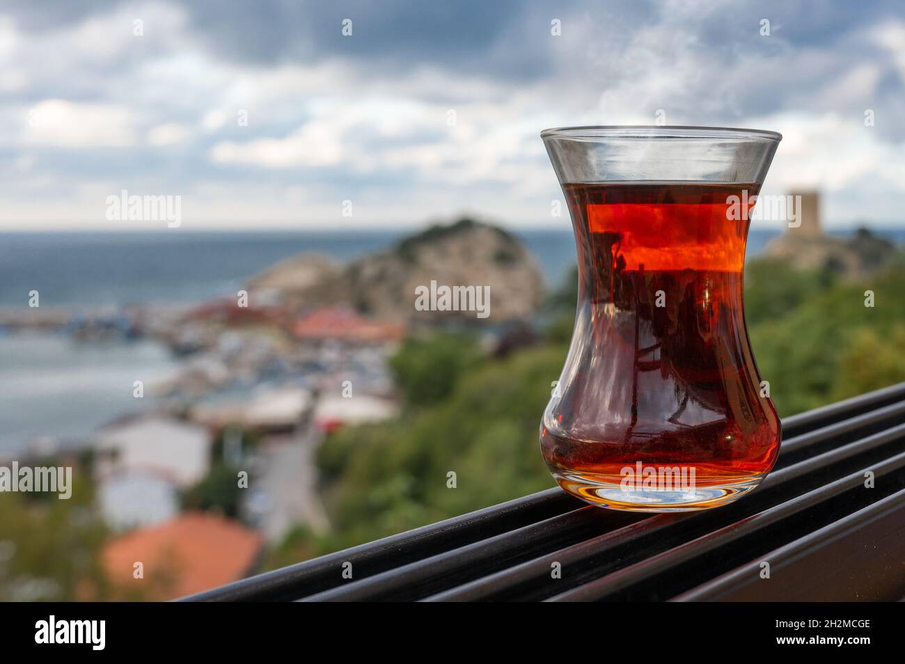 Tea cup armudas on woman hand, traditional Turkish tea against ...