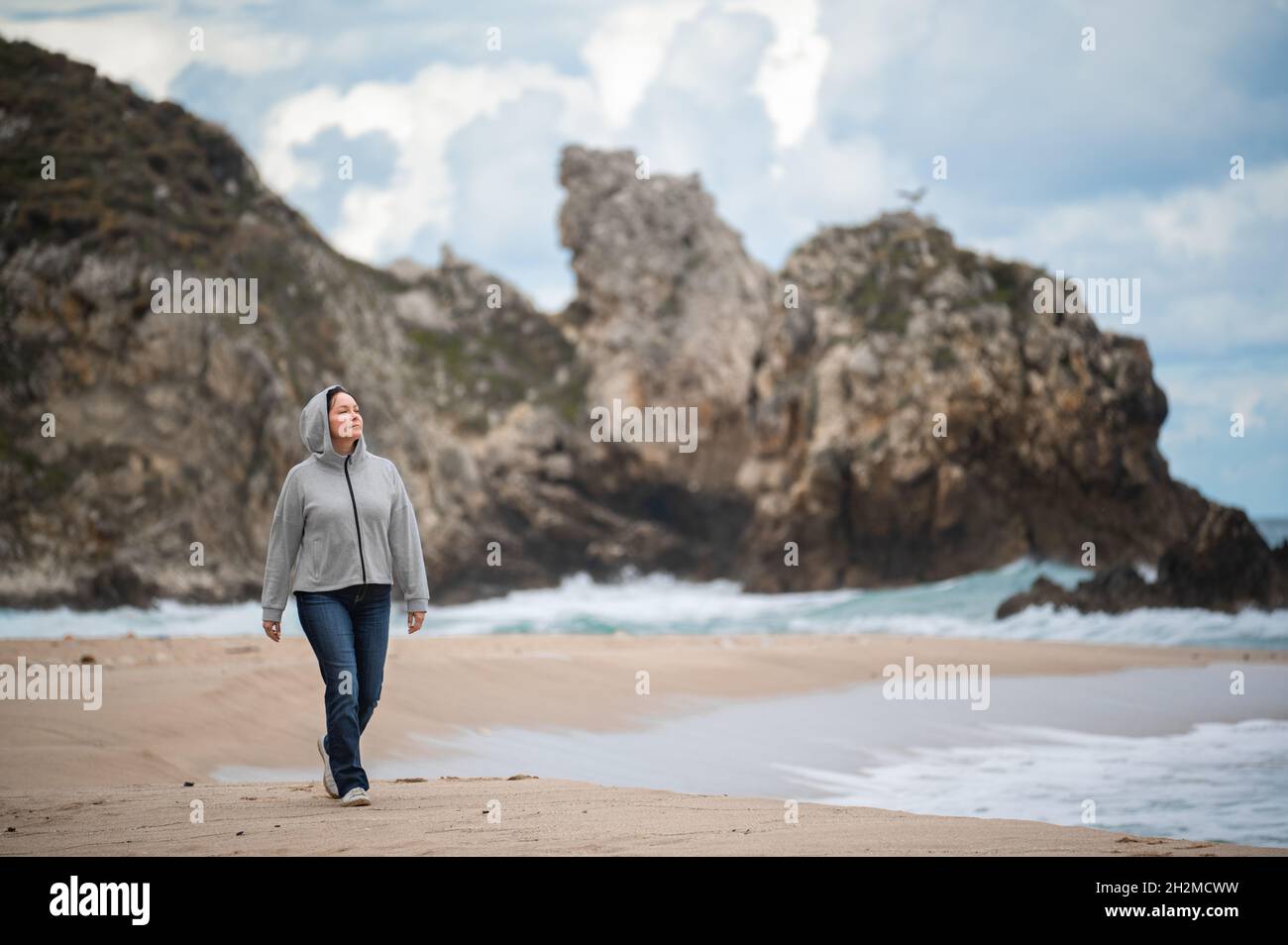 happy middle aged woman walking on beach Stock Photo - Alamy