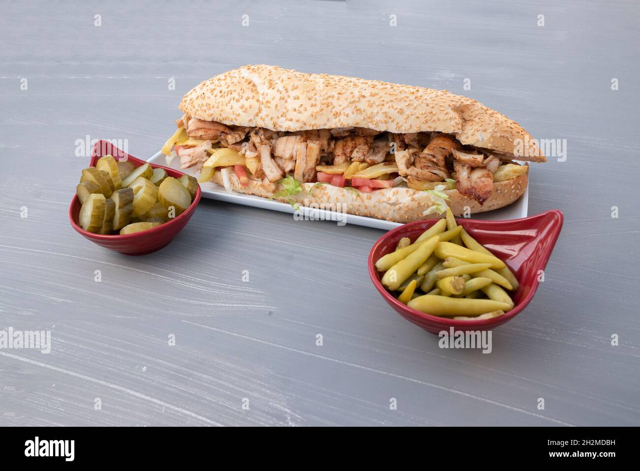 Turkish chicken doner between bread, chicken pieces and bread on the ...