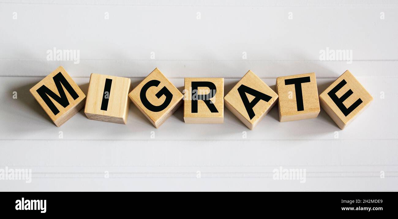 Migrate text written on wooden blocks and a light background Stock ...