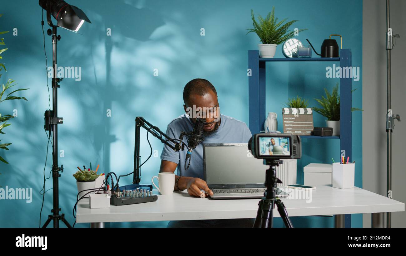 Blogger doing product review for laptop and keyboard in studio ...