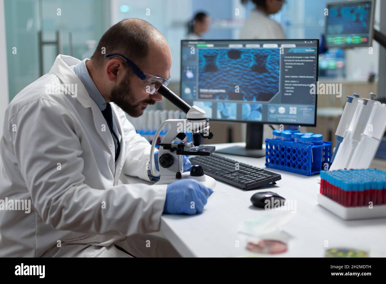 Specialist virus researcher analyzing coronavirus result using clinical ...