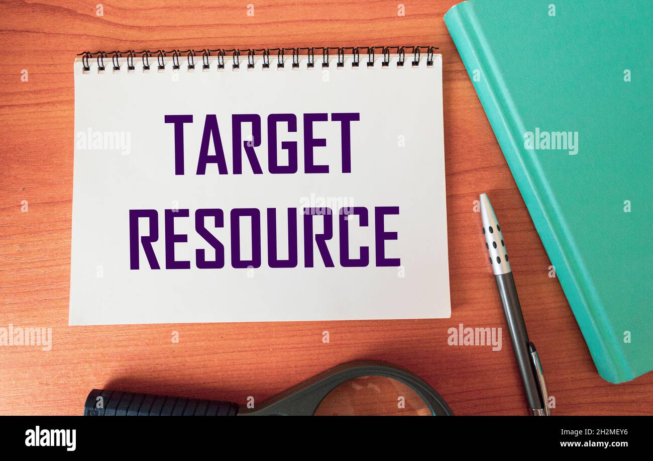 Target resource - text in a notebook and a wooden table with a ...
