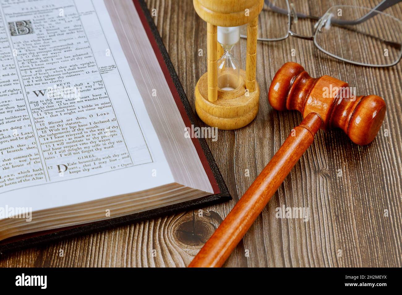 Time is running out according to the Bible with hourglass judge's gavel ...