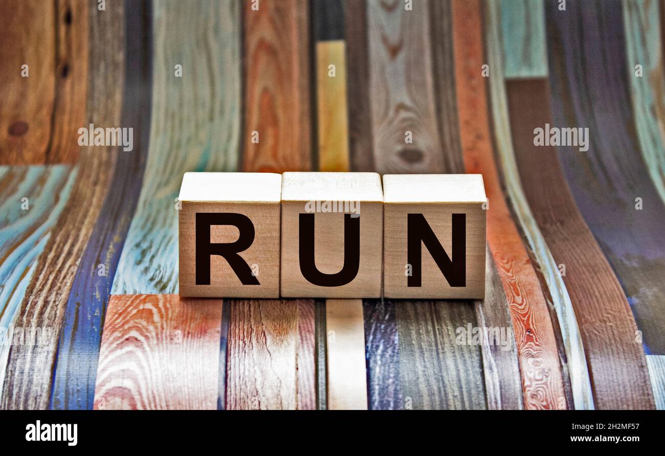 Run written on blocks and wooden background Stock Photo - Alamy