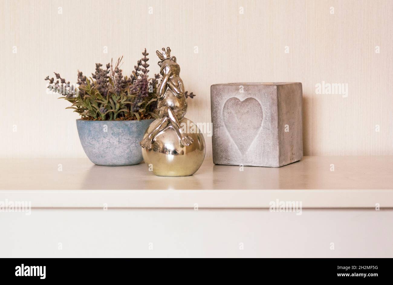 Still life from a vase with lavender, a figurine of a frog with a ...