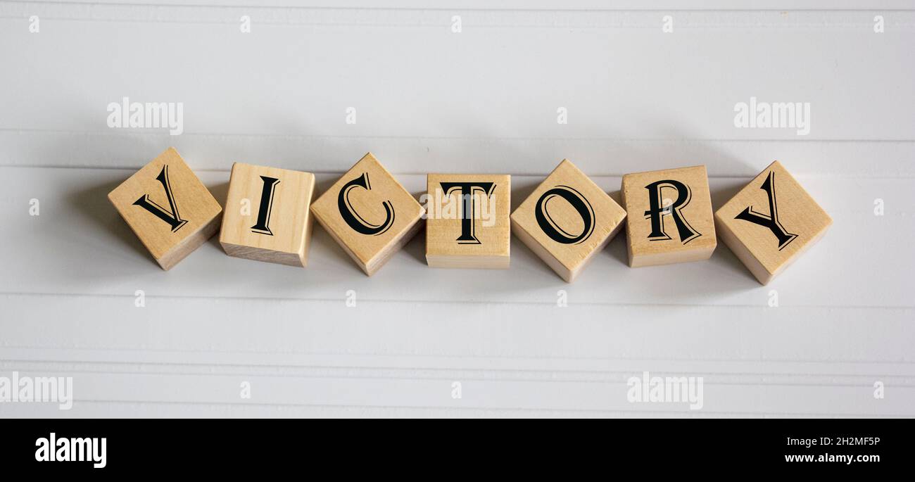 The word victory made of wooden cubes on a white background Stock Photo ...