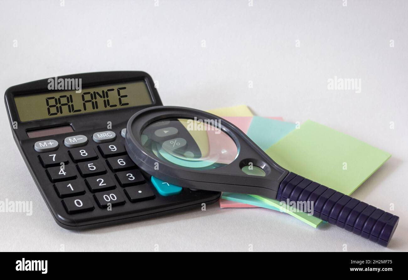 Calculator with the text Balance on a white background, near a ...