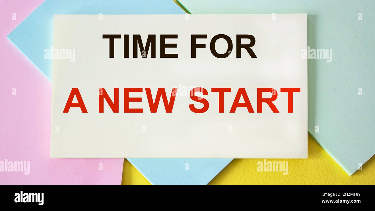 TIME FOR A NEW START written on a colored sticker and a colorful ...