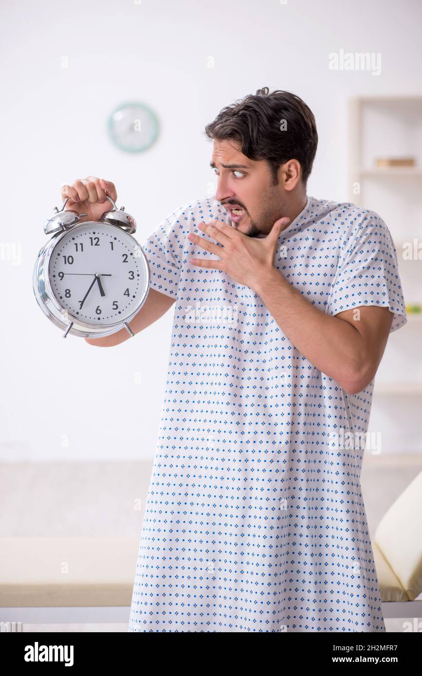 Young patient in time management concept Stock Photo - Alamy
