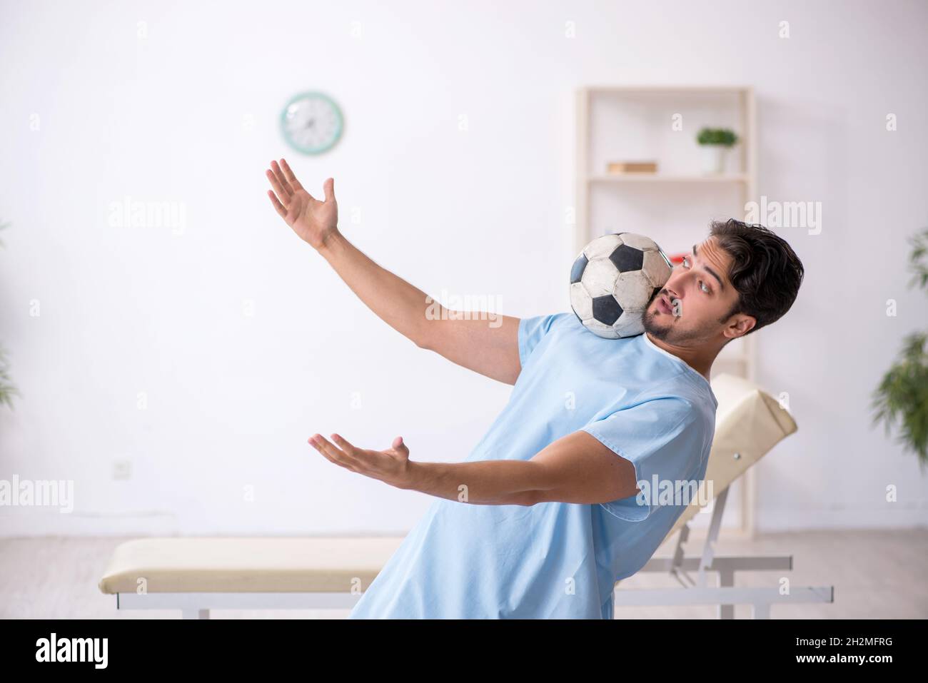 Young male patient playing football at the hospital Stock Photo - Alamy