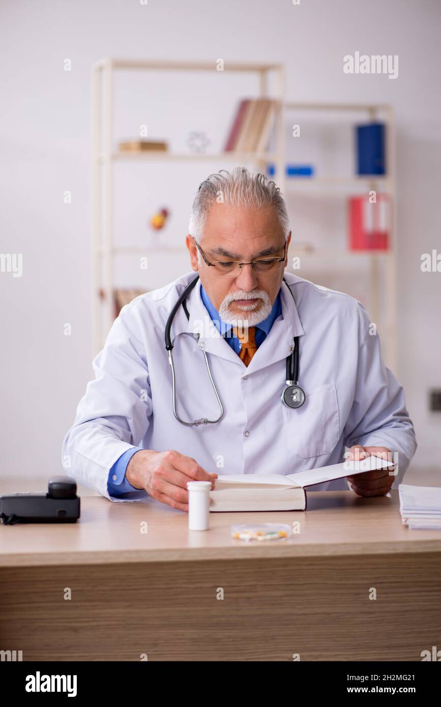 Old doctor working in the clinic Stock Photo - Alamy