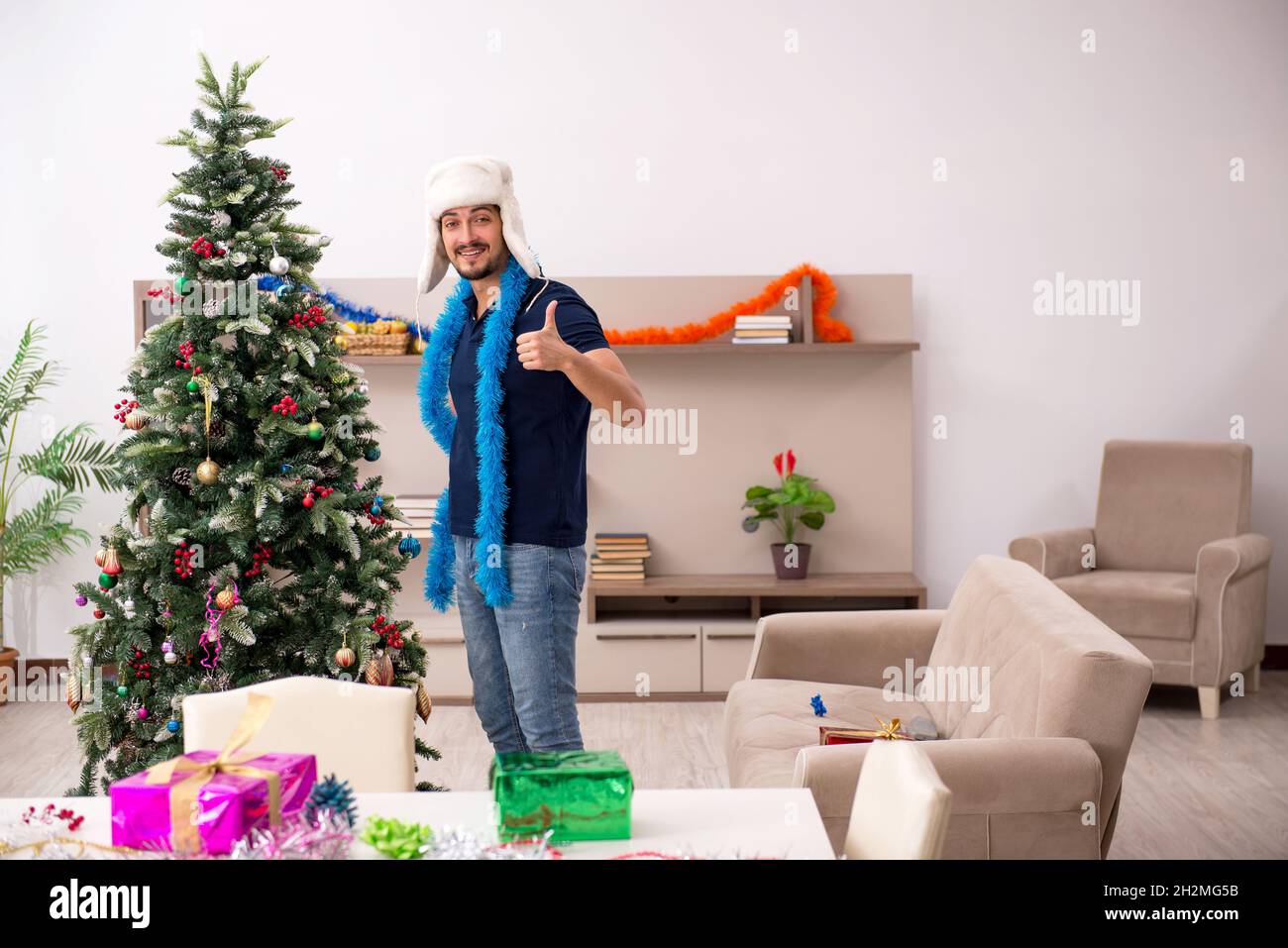 Young man celebrating New year at home alone Stock Photo - Alamy