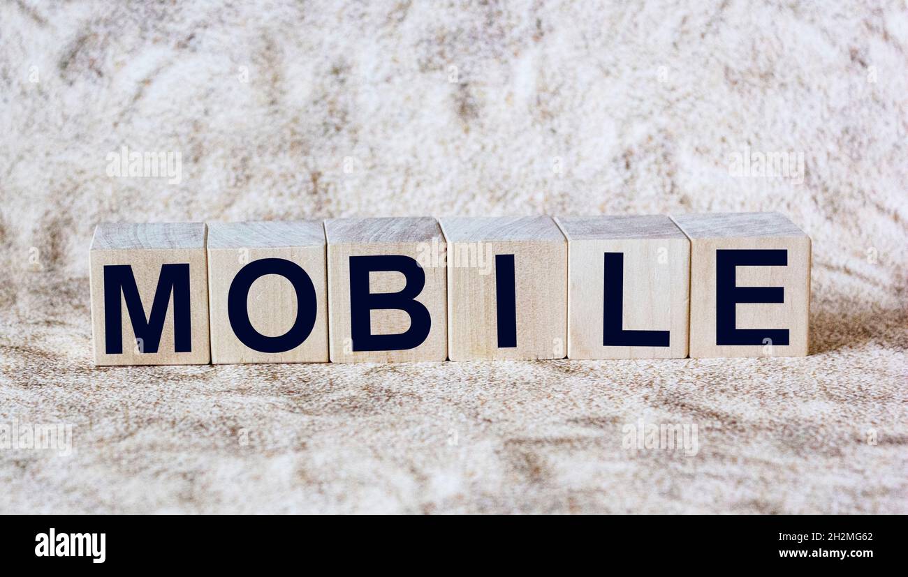 word Mobile written on wooden cubes and light background Stock Photo ...