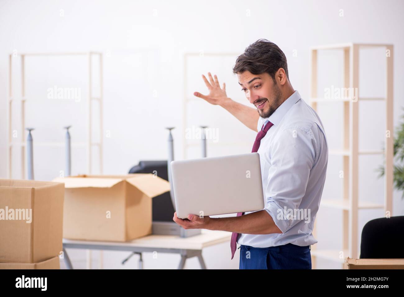 Young employee in relocation concept Stock Photo - Alamy