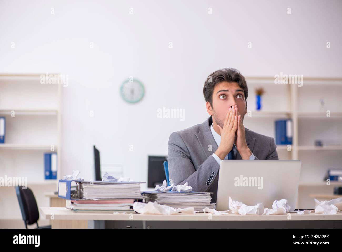 Young employee and too much work in the office Stock Photo - Alamy