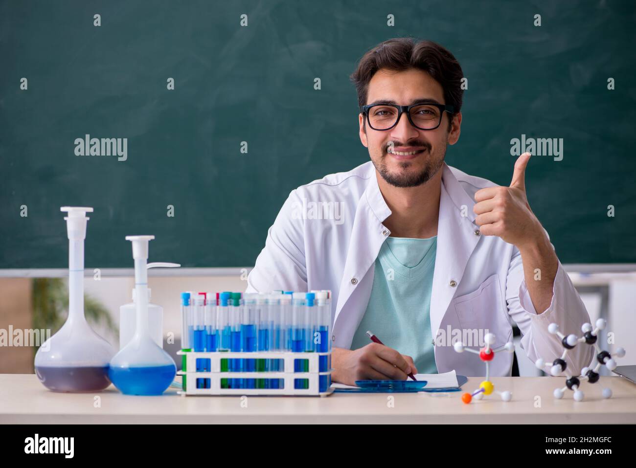 Young chemist in front of blackboard Stock Photo - Alamy