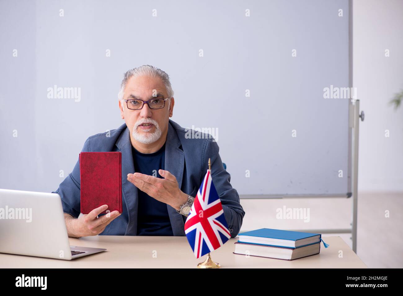 Old english language teacher in the classroom Stock Photo - Alamy