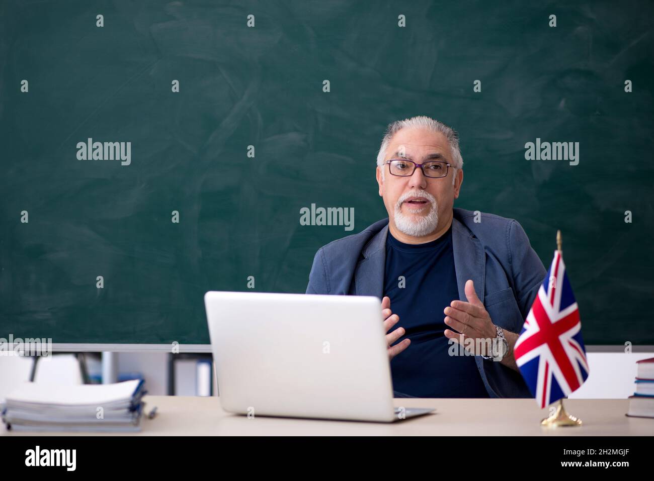 Old english language teacher in the classroom Stock Photo - Alamy
