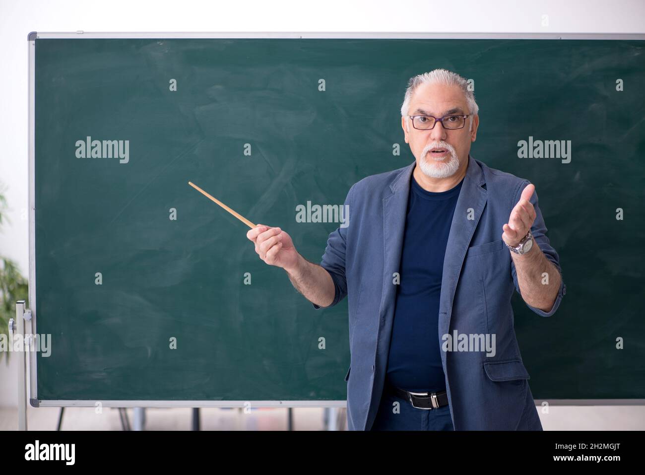 Old teacher in the classroom Stock Photo - Alamy