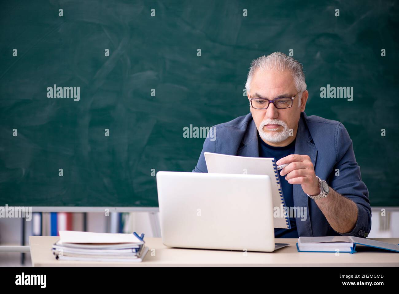 Old teacher in the classroom Stock Photo - Alamy
