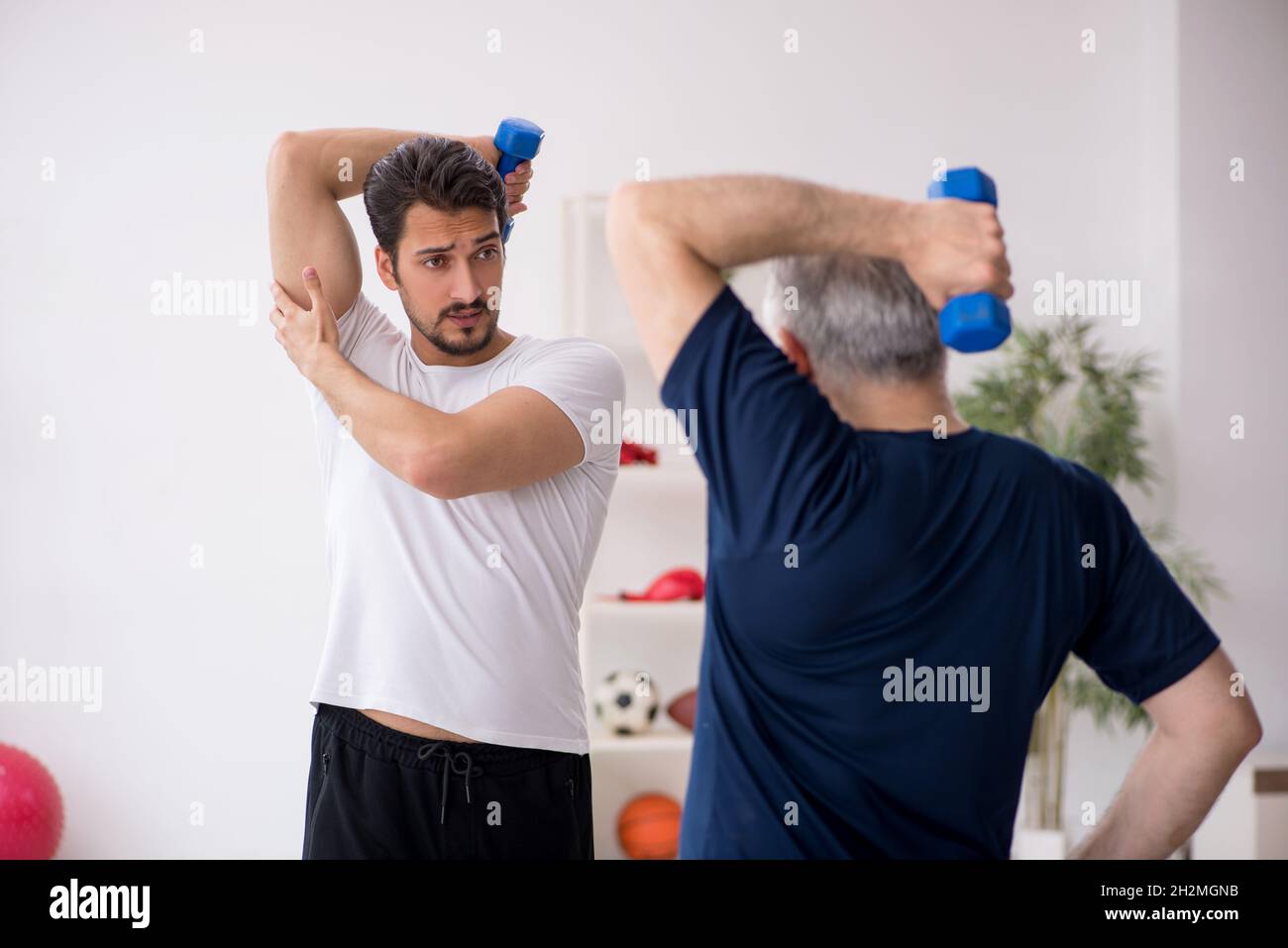 Fitness instructor showing stretching exercises hi-res stock ...