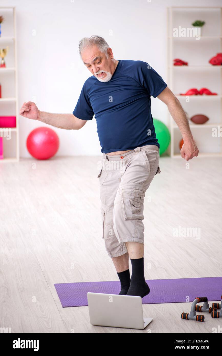 Old man doing sport exercises at home Stock Photo - Alamy