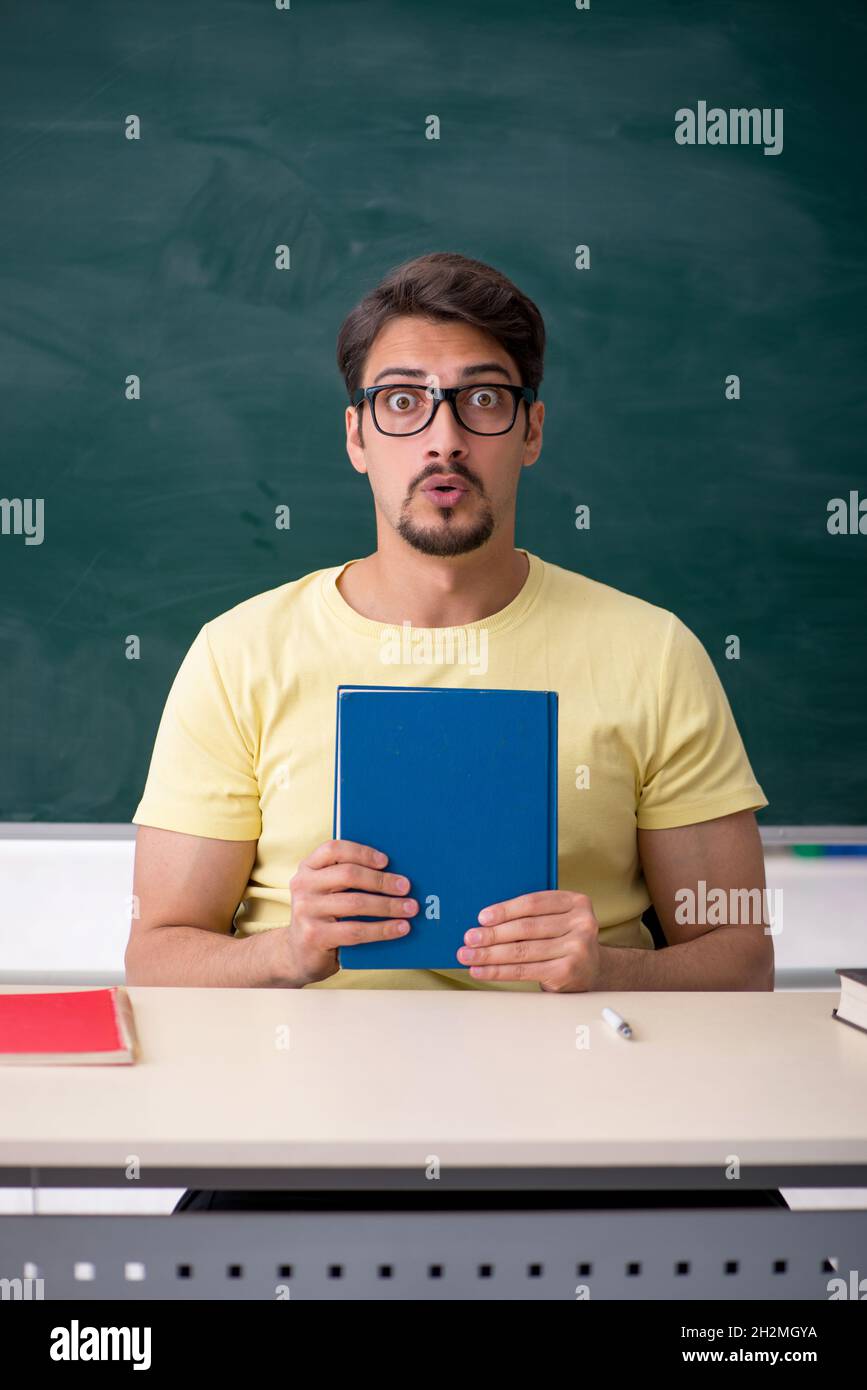 Young student in front of blackboard Stock Photo - Alamy