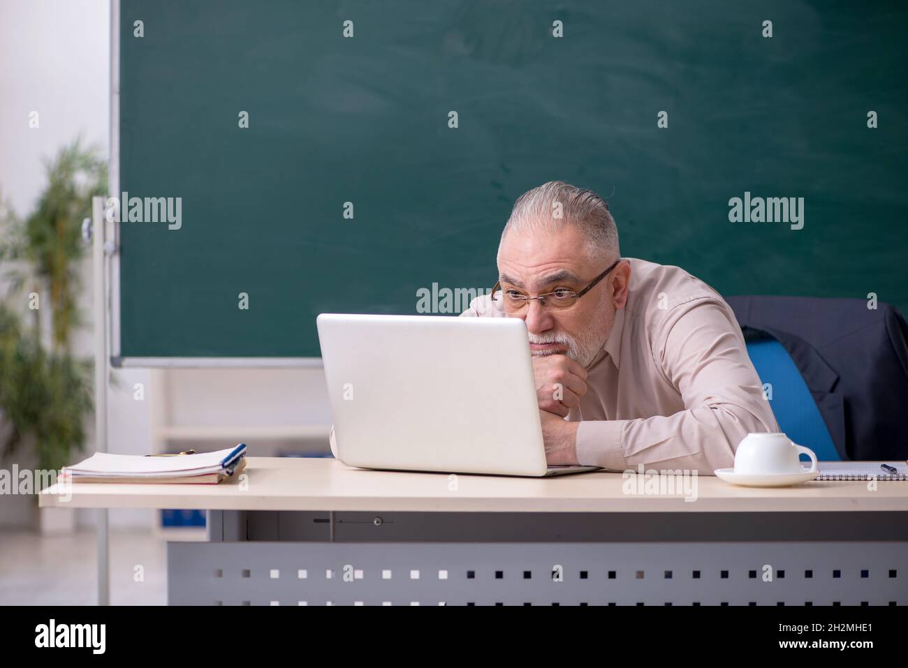 Old teacher in front of blackboard Stock Photo - Alamy
