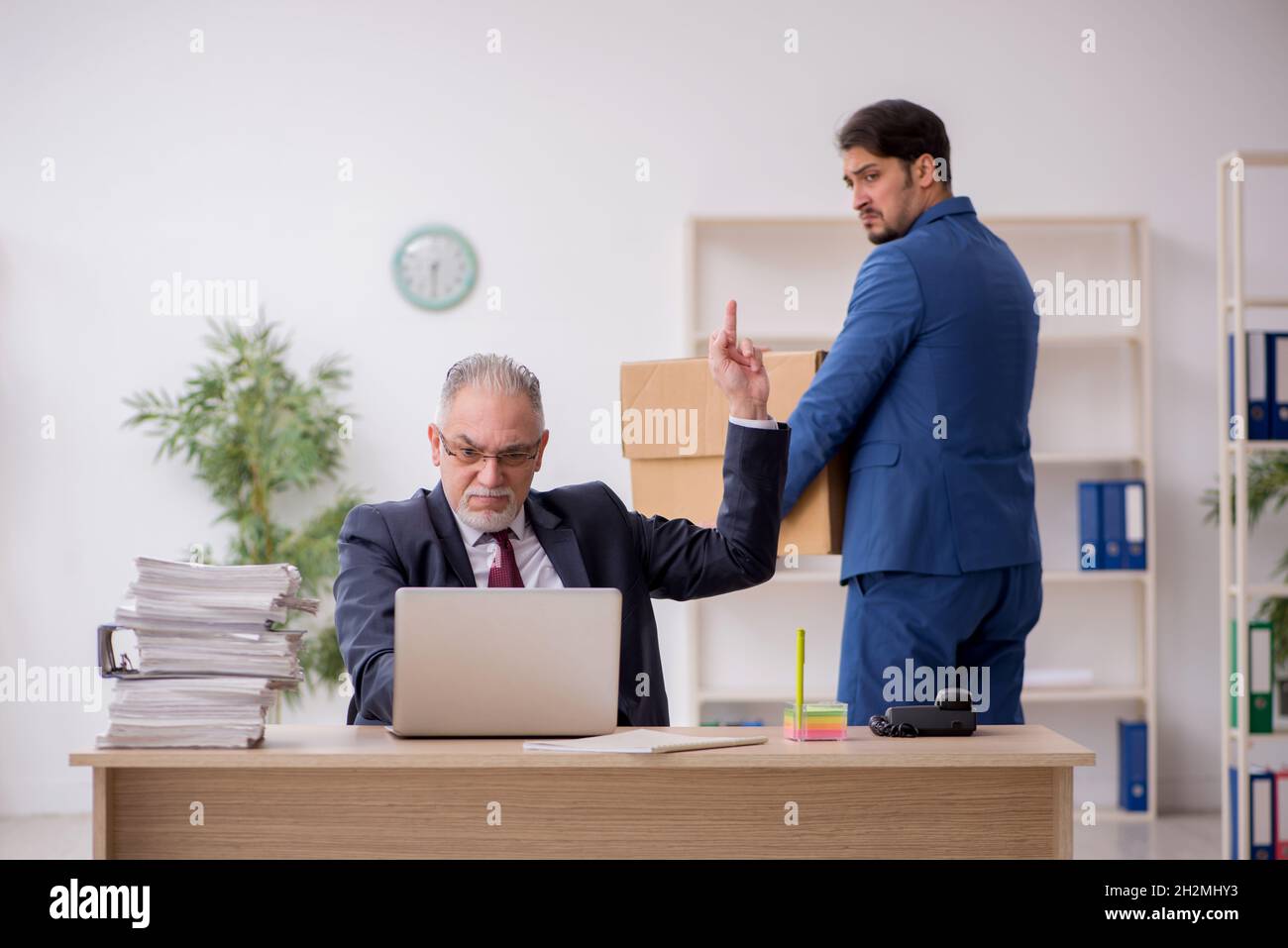 Two employees in dismissal concept Stock Photo - Alamy
