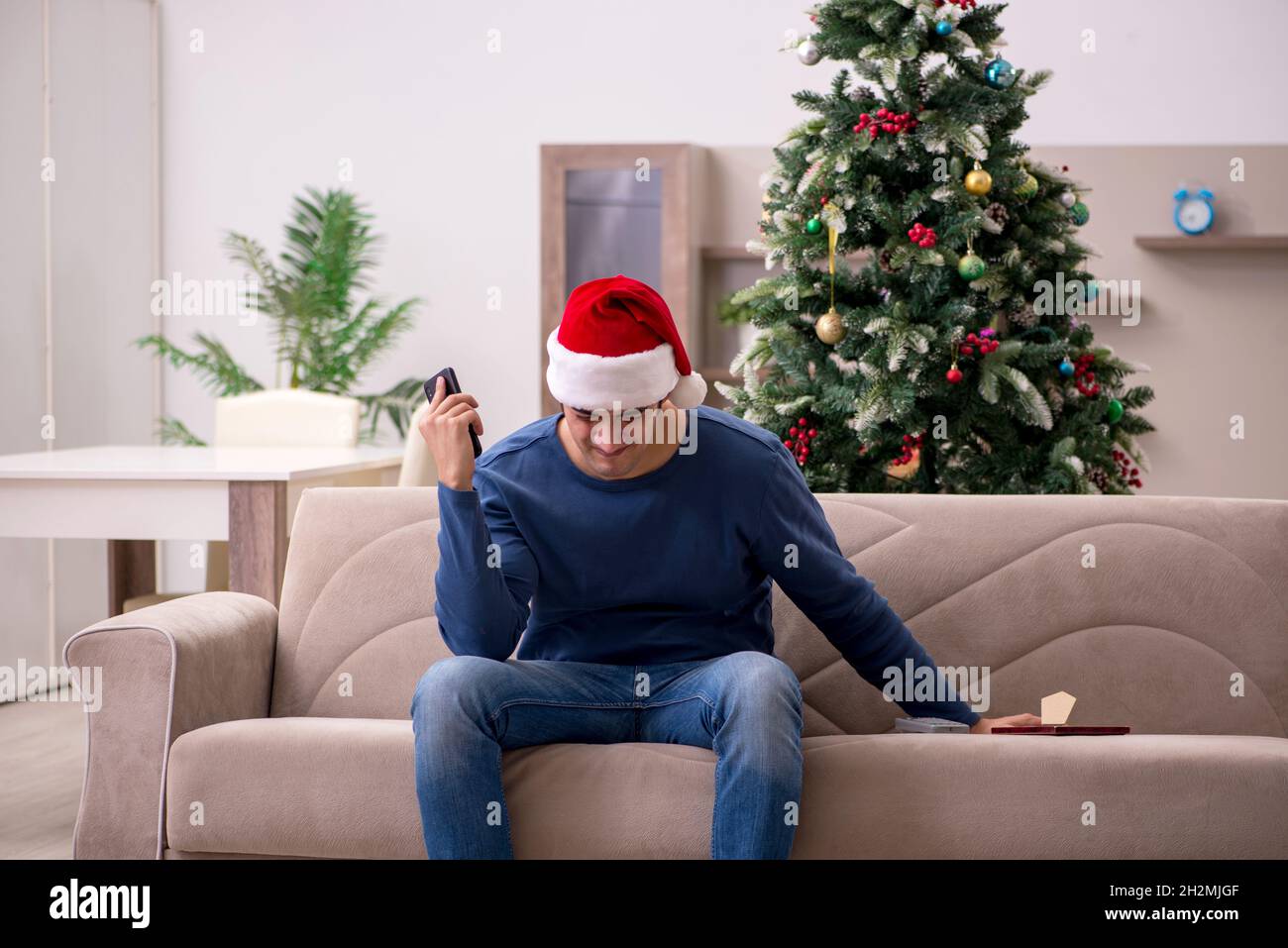 Young man celebrating new year alone at home Stock Photo - Alamy