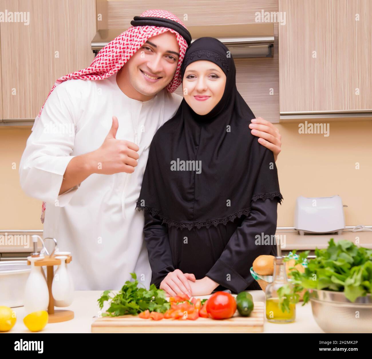 The young arab family in the kitchen Stock Photo - Alamy