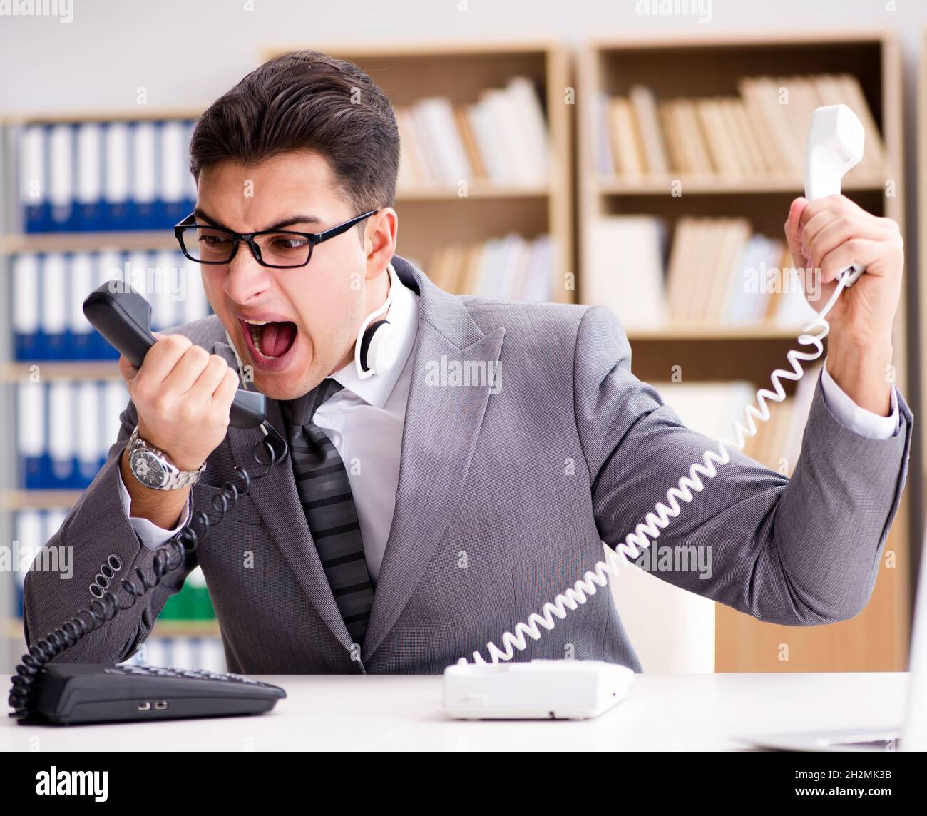 The angry helpdesk operator yelling in office Stock Photo - Alamy