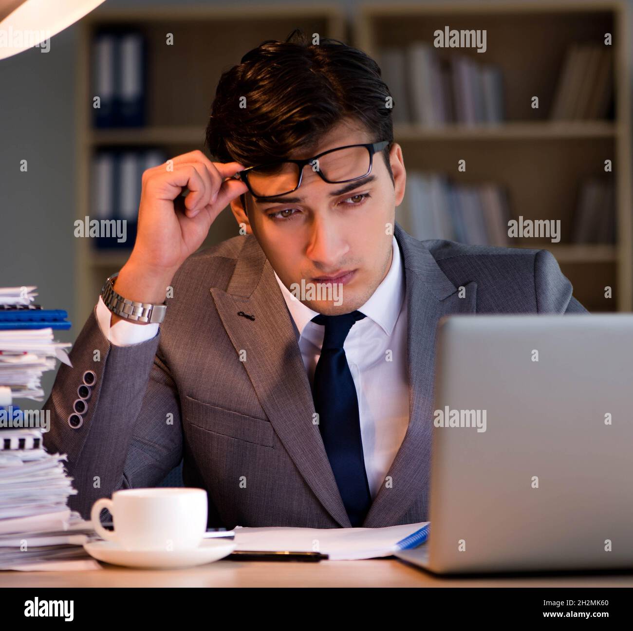 The businessman staying in the office for long hours Stock Photo - Alamy