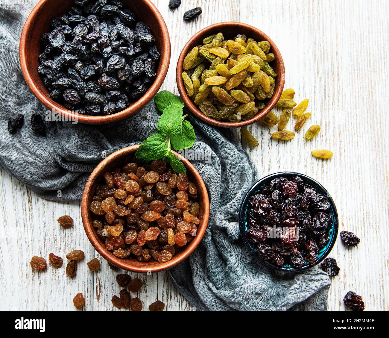 Collection of various raisins on a white wooden background Stock Photo ...