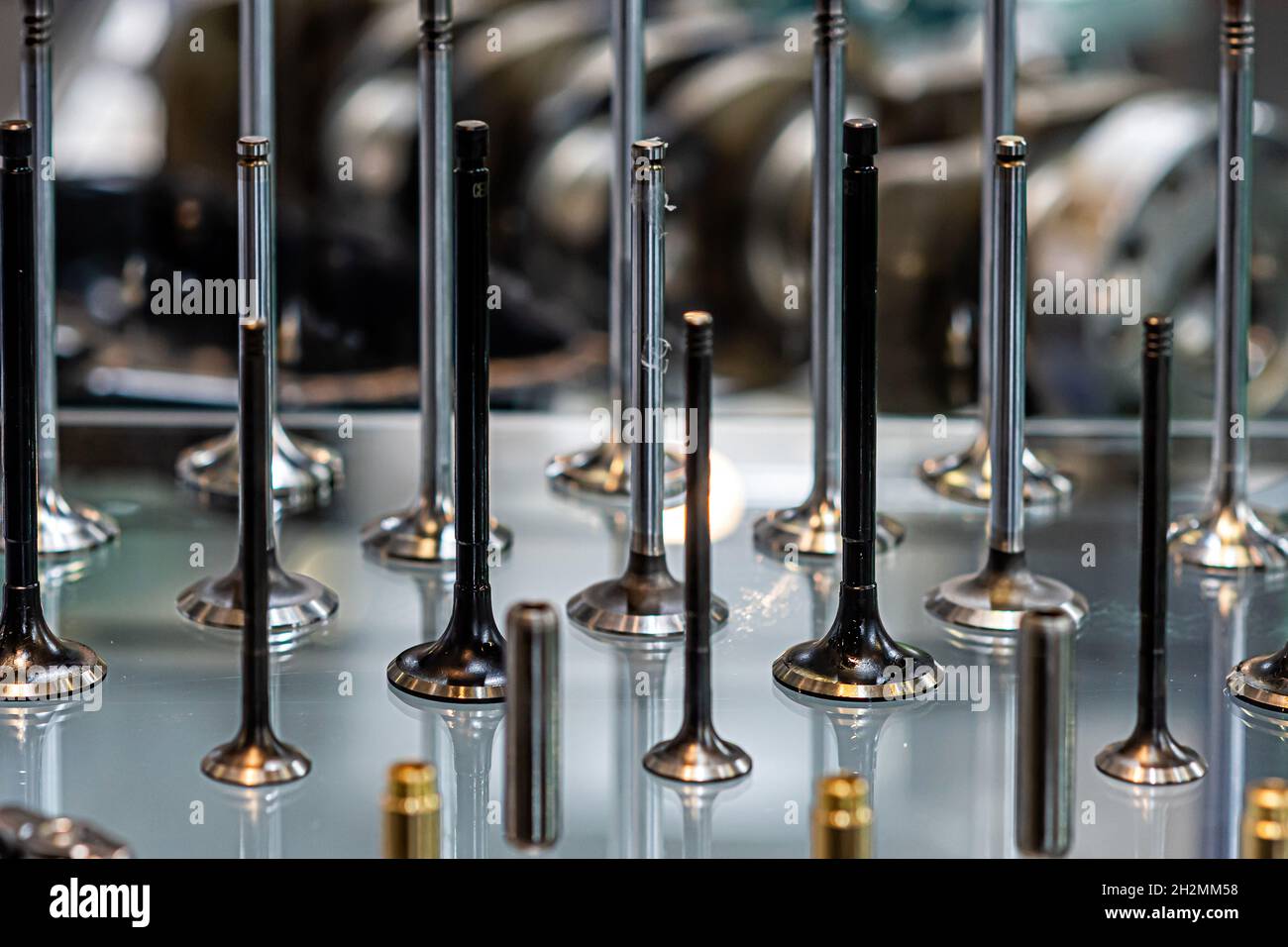 abstract background with car engine valves in a glass showcase, close ...