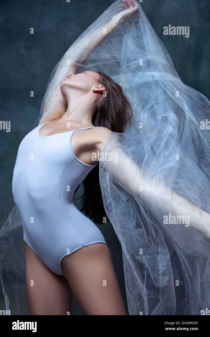 Close-up of young beautiful girl, ballerina posing with white ...