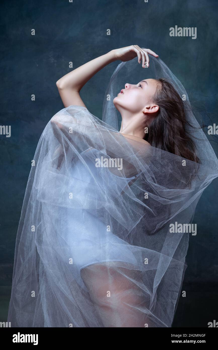 Close-up of young beautiful girl, ballerina posing with white ...