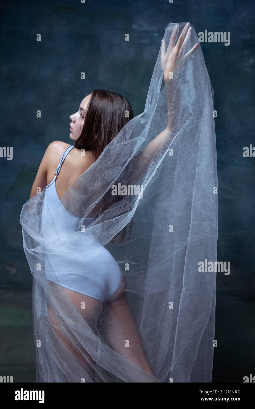 Close-up of young beautiful girl, ballerina posing with white ...