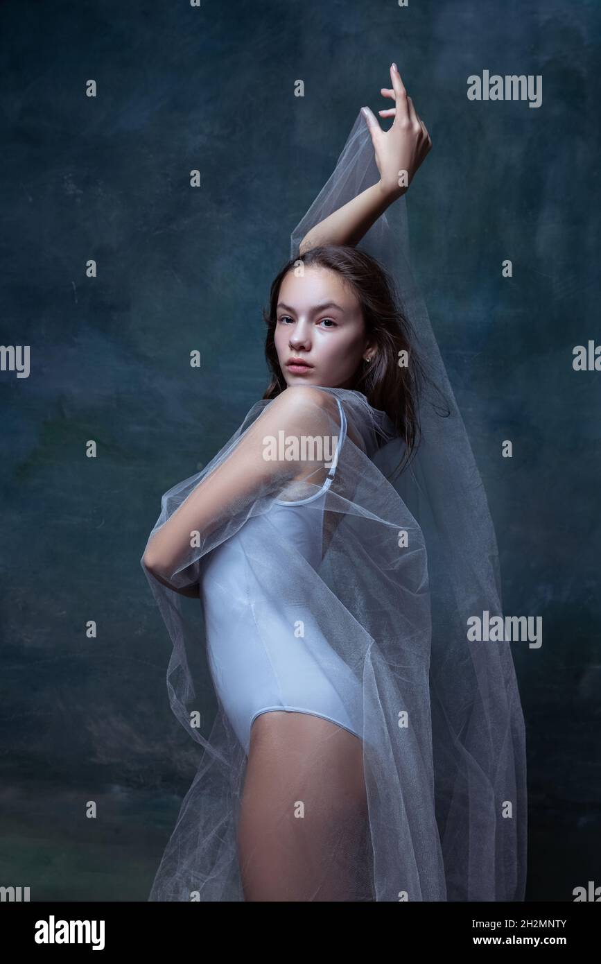 Close-up of young beautiful girl, ballerina posing with white ...