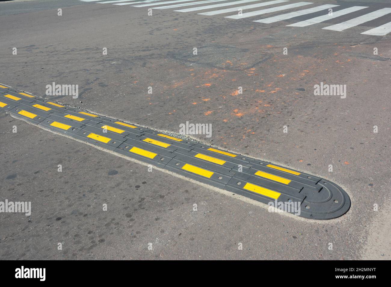 Traffic safety speed bump with crosswalk on an asphalt road. Speed ...