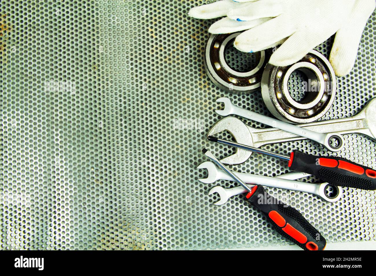 Metalworking tools, steel parts, a wrench, on the background of a metal ...