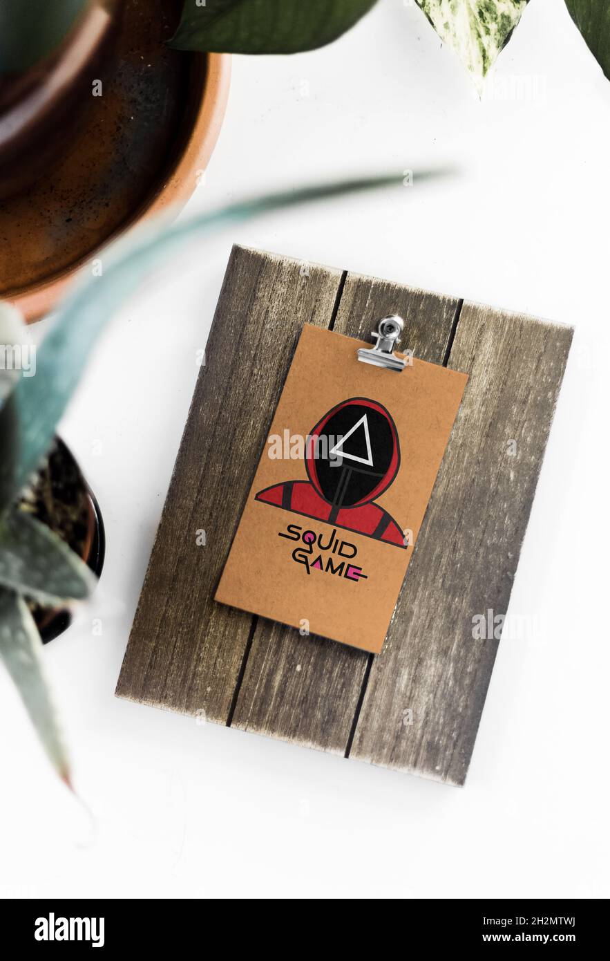 Squid Game Wallpapers with Red Triangle Guard Character Stock Photo - Alamy