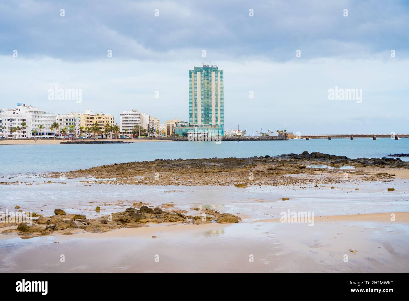 Landscape of beach and harbor of the spanish city of Arrecife in ...