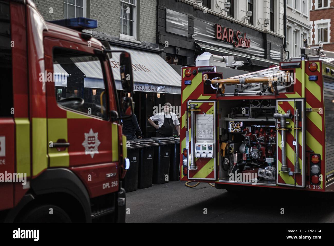 A chef looks on in Soho, London as the fire brigade investigate an ...