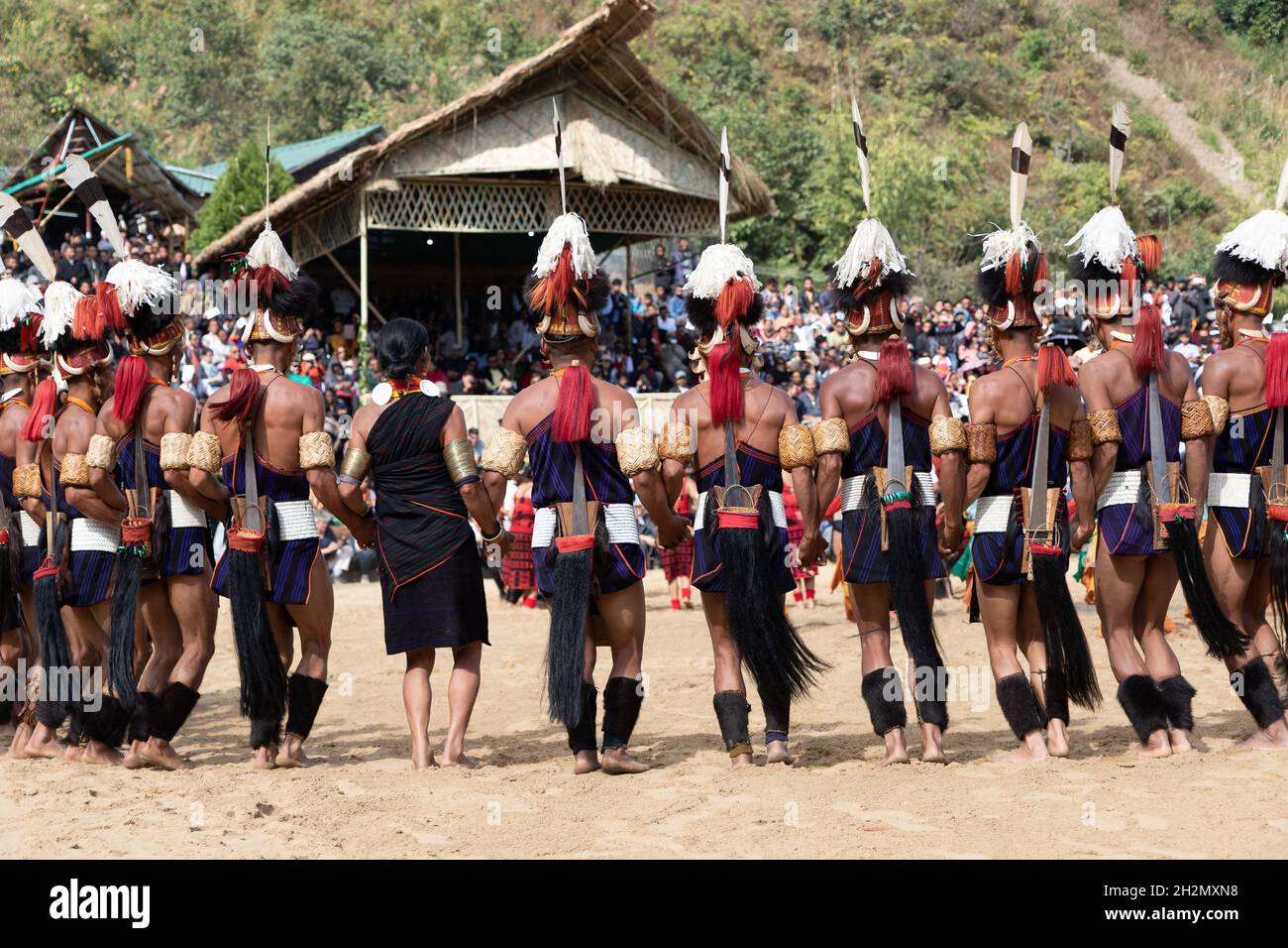Naga tribesmen and women dressed in their traditional attire dancing at ...